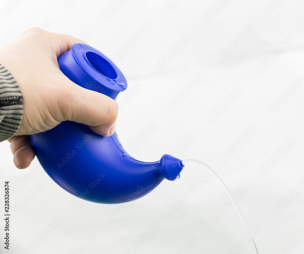 Use of a device for washing the nose. The hand holds the device with a ...
