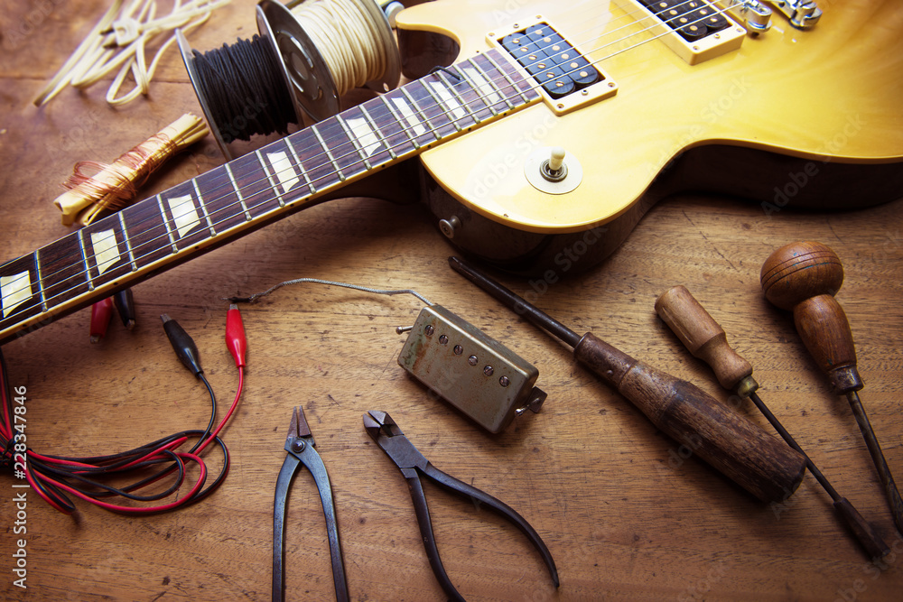 Guitar on guitar repair desk. Vintage electric guitar on a guitar ...