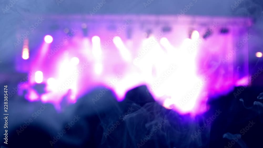 Blurred scene of a rock concert with musicians on stage and the crowd ...