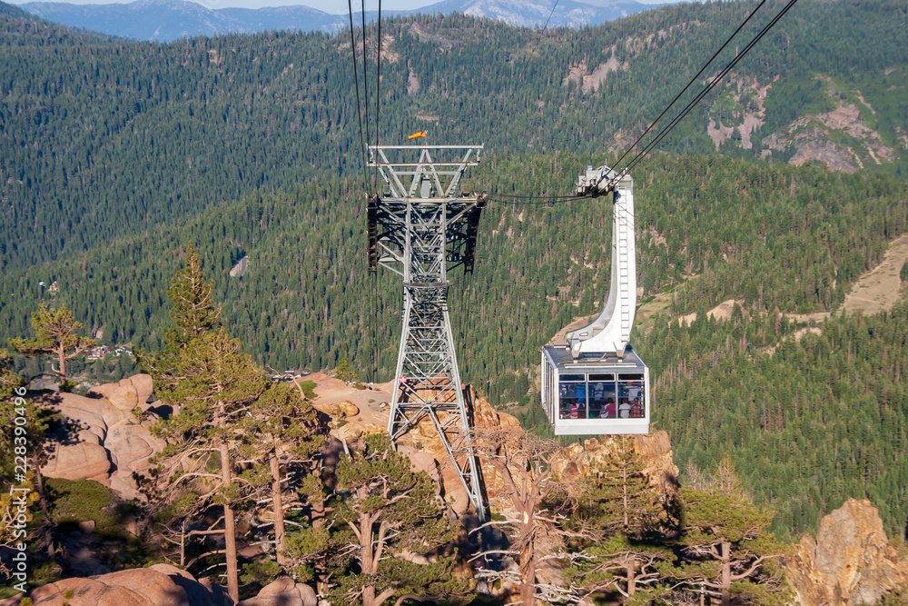 A cable car gondola moves toward a cable support structure to hold up ...