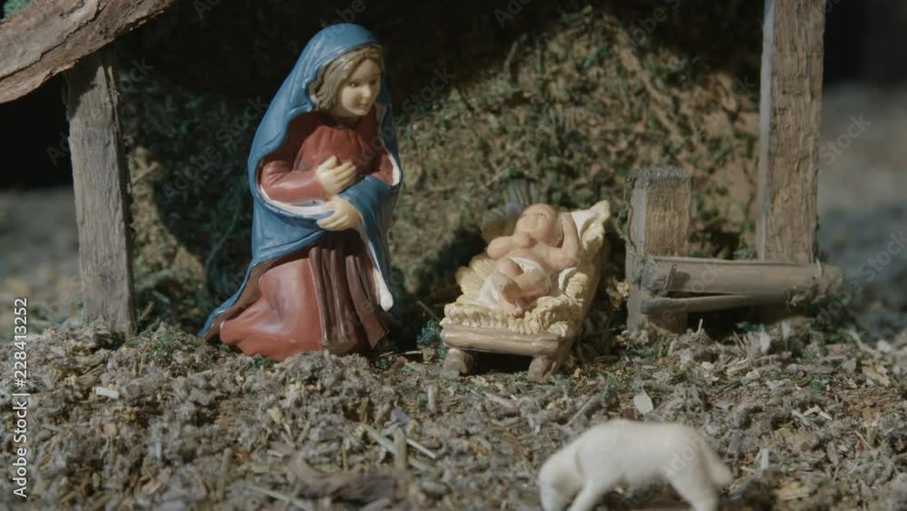 Nativity scene with figurines in the manger including baby Jesus ...
