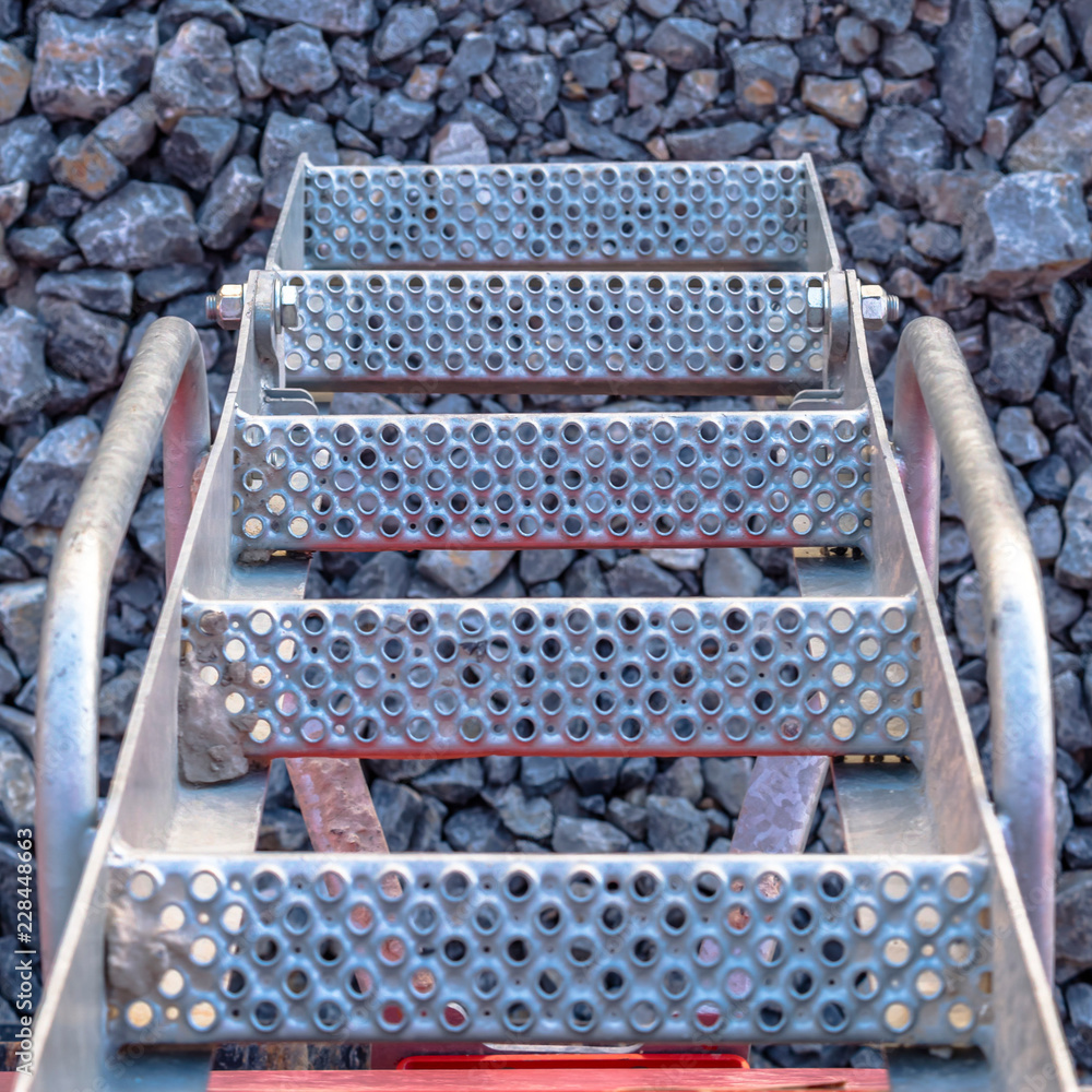 Perforated metal stairs on a stone ground Stock Photo | Adobe Stock