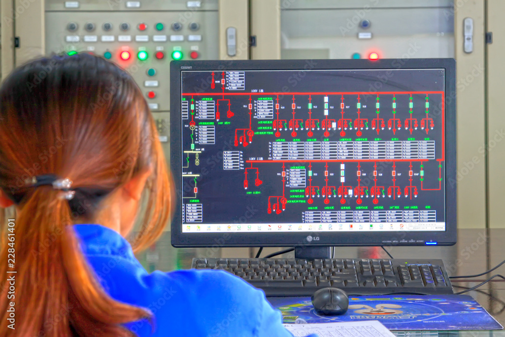 Female technician in view display state in the control room, in a iron ...