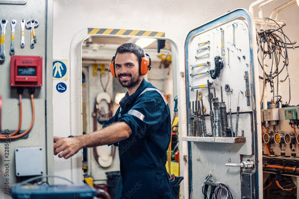 Marine engineer officer in engine control room ECR. Seamen's work. He ...
