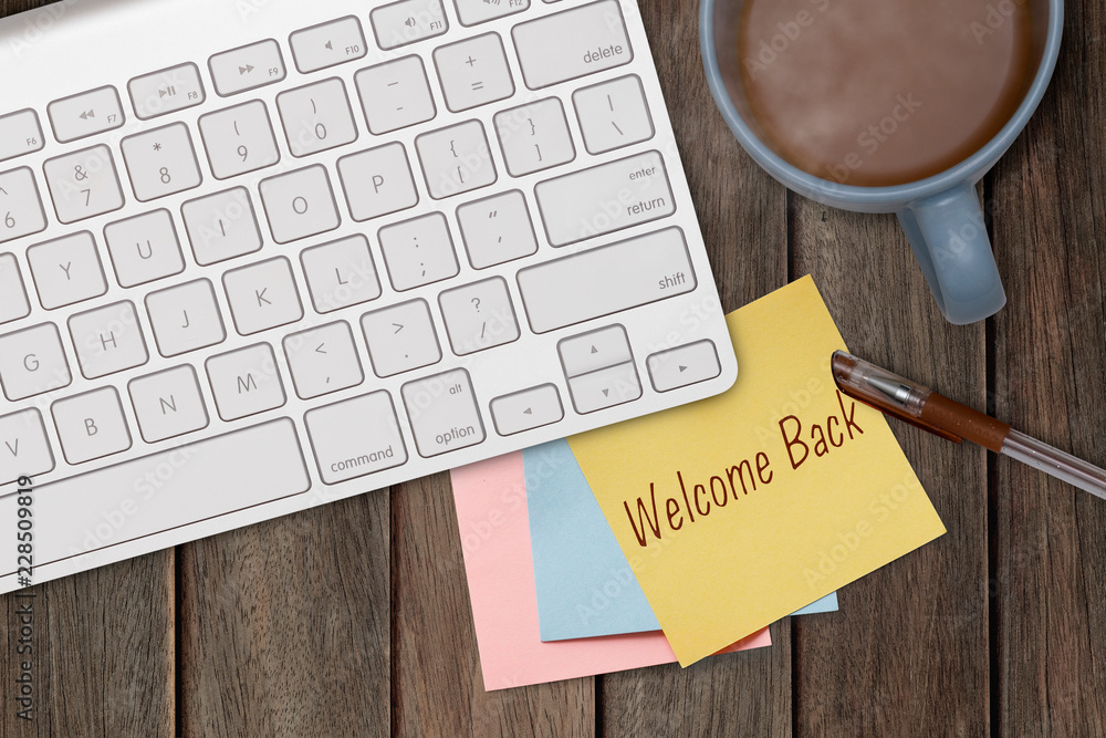 WELCOME BACK WORD ON PAPER NOTE WITH COMPUTER KEYBOARD, HOT COFFEE, AND ...