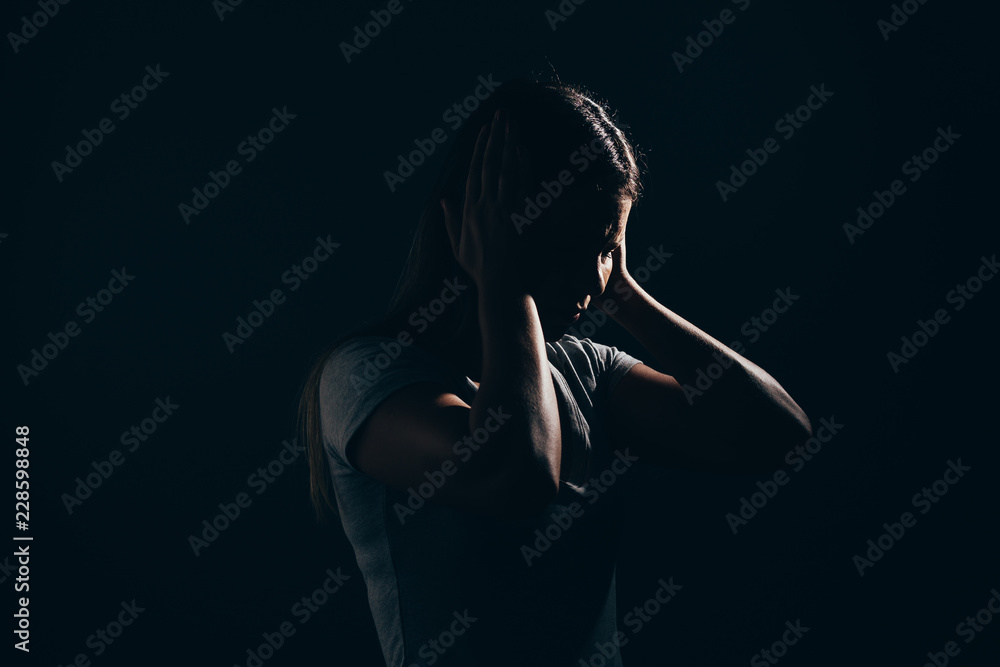 Sad woman in dark room. Depression and anxiety disorder concept Stock ...