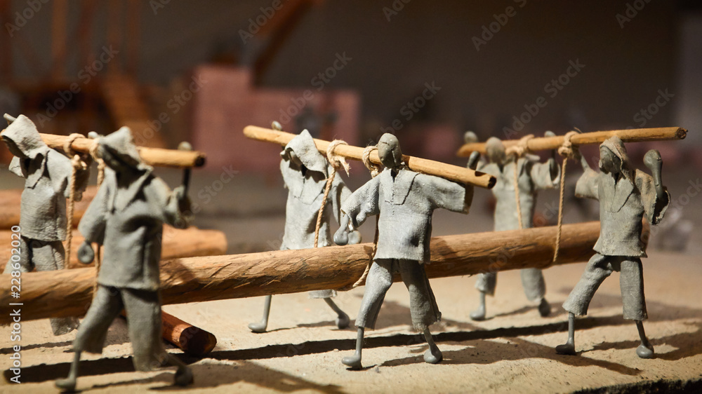 Sculpture composition, people carry log, symbol hard work Stock Photo ...