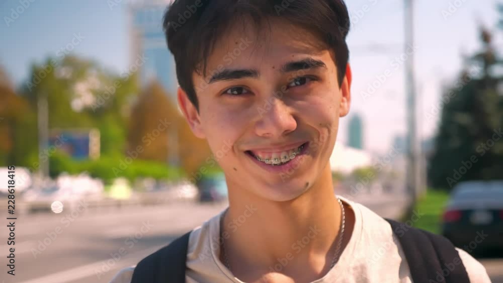 Vidéo Stock Shy sincere smile of asian man in braces looking straight ...
