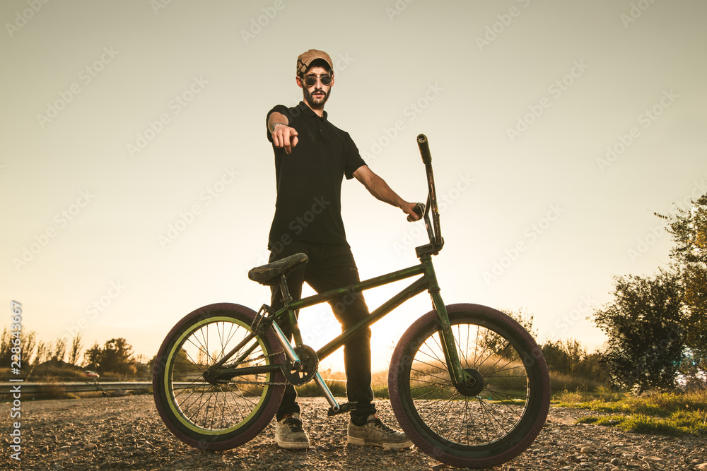 Bmx bike rider in a sunset. Guy riding a bmx bike Stock Photo | Adobe Stock