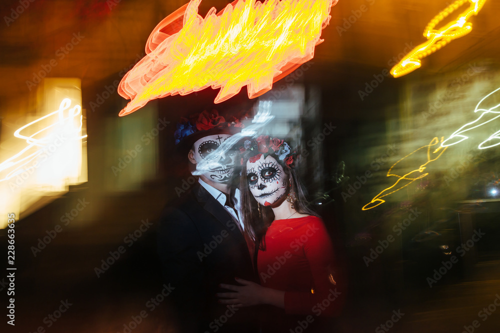 Blur. A man and a woman with a visage, a pattern of skulls, a zombie on ...