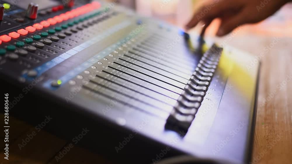 The DJ is adjusting the volume of the sound. Professional audio mixing ...