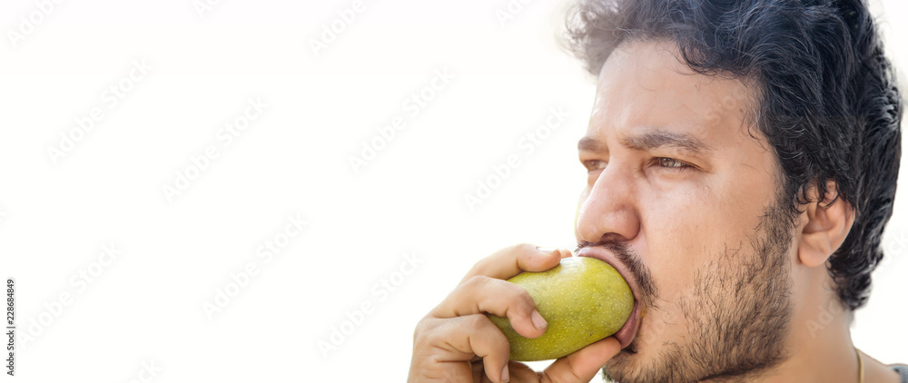 Indian man eating mango on white background Stock Photo | Adobe Stock