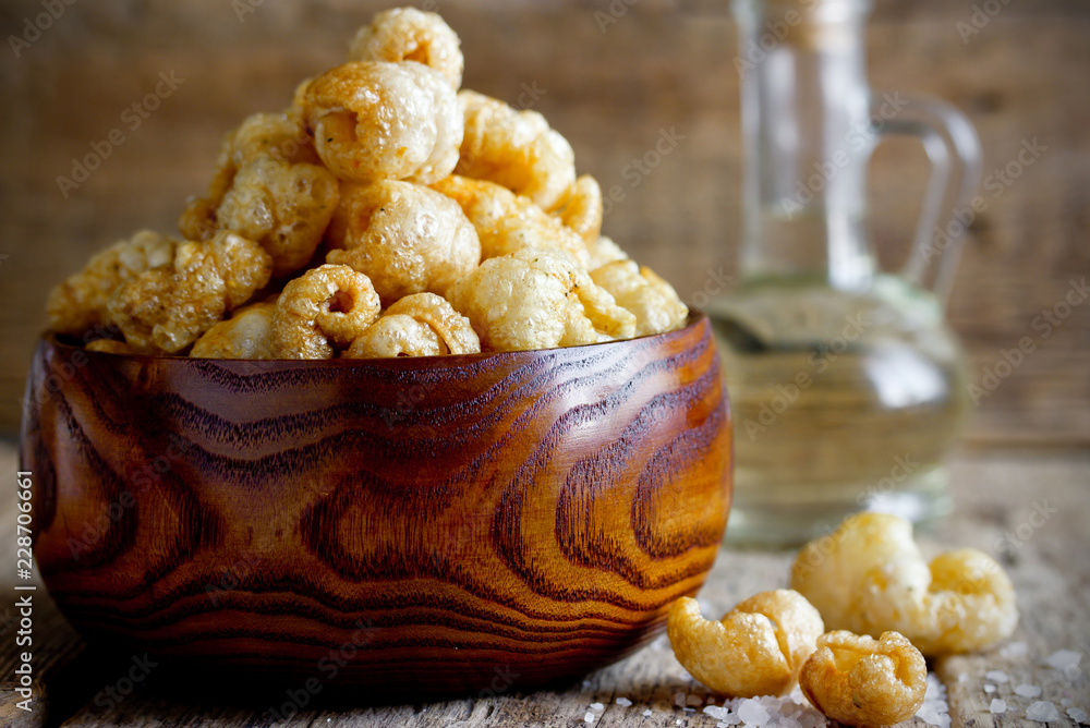 Chicharron - deep fried pork rinds, crispy pork skin pieces in wooden ...