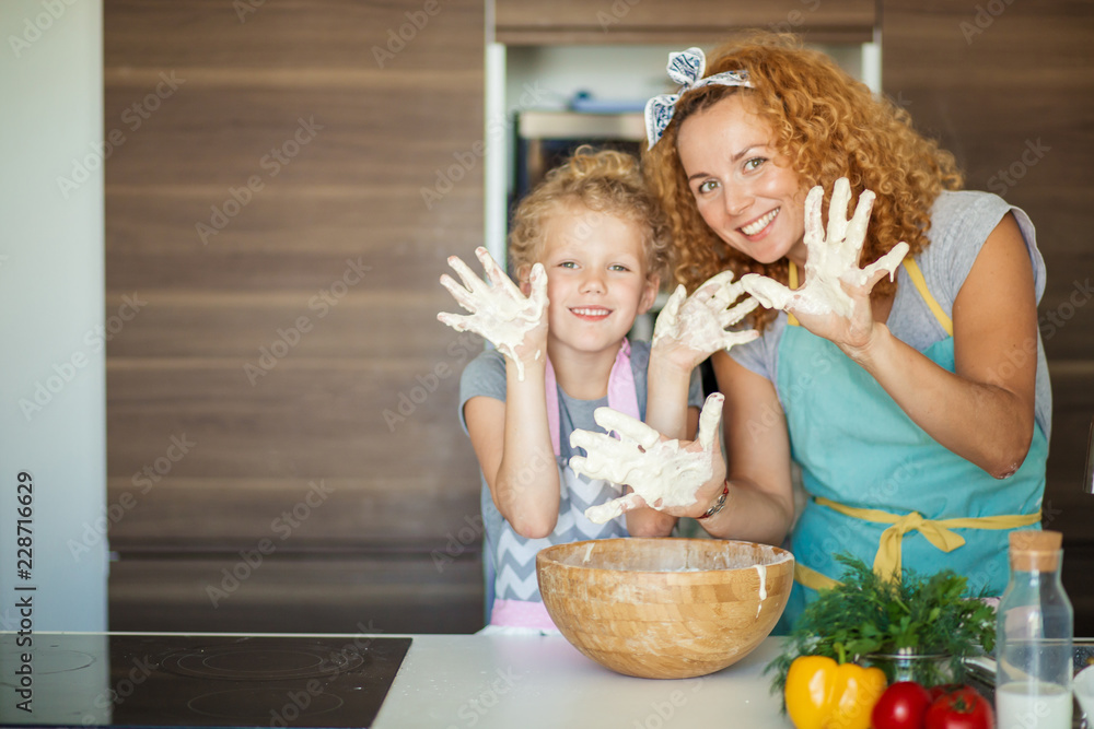Happy loving caucasian Mom and daughter preparing bakery together ...