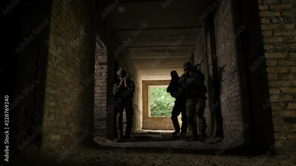 Army soldiers in full uniform during the military operation on enemy ...