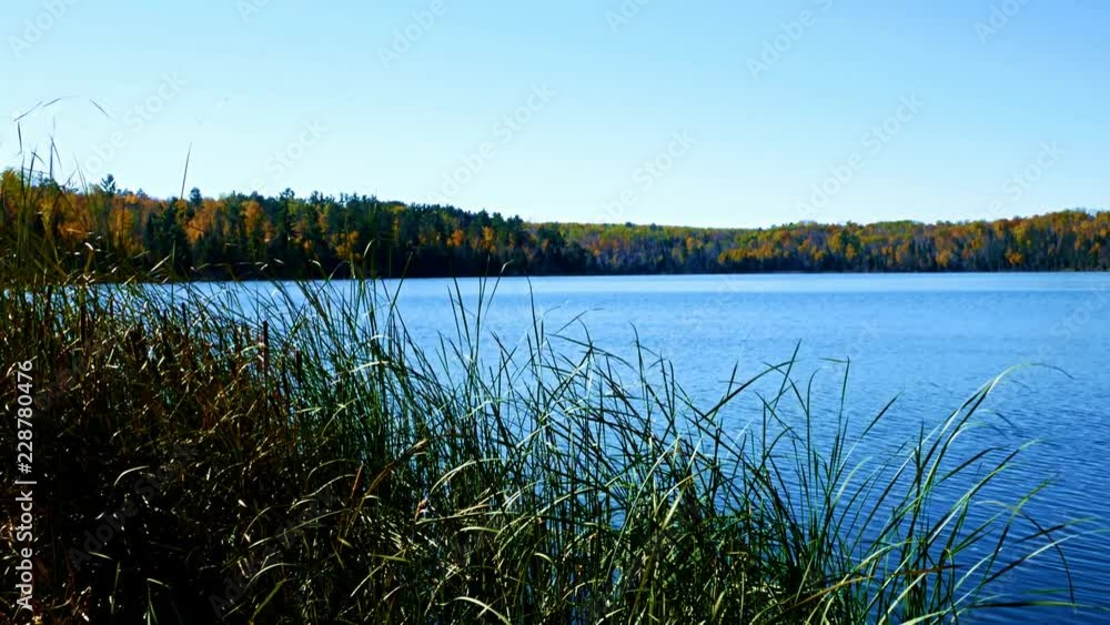 Blue sky with sunshine over beautiful serene remote northern Minnesota ...