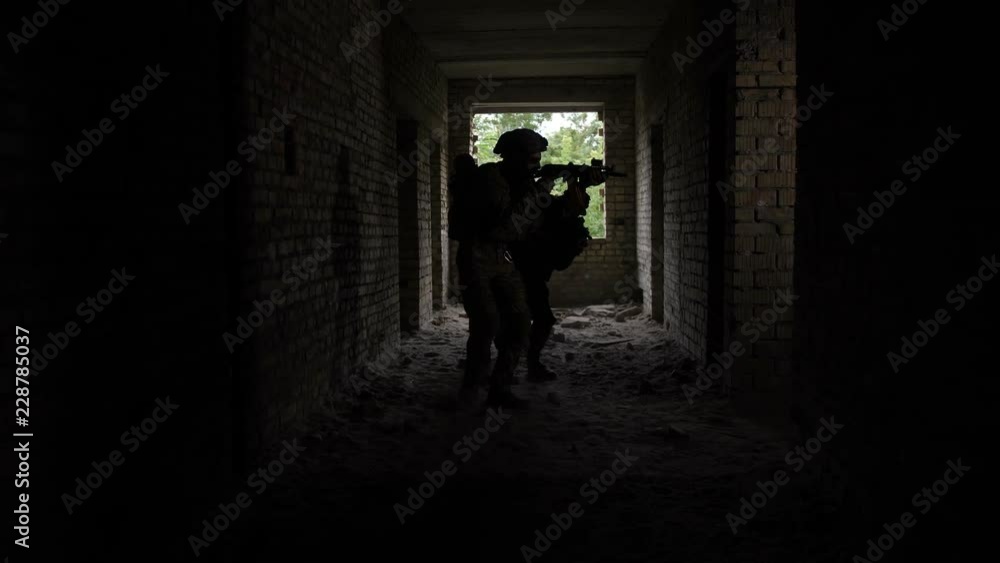 Group of soldiers in camouflage with weapons and tactical devices ...