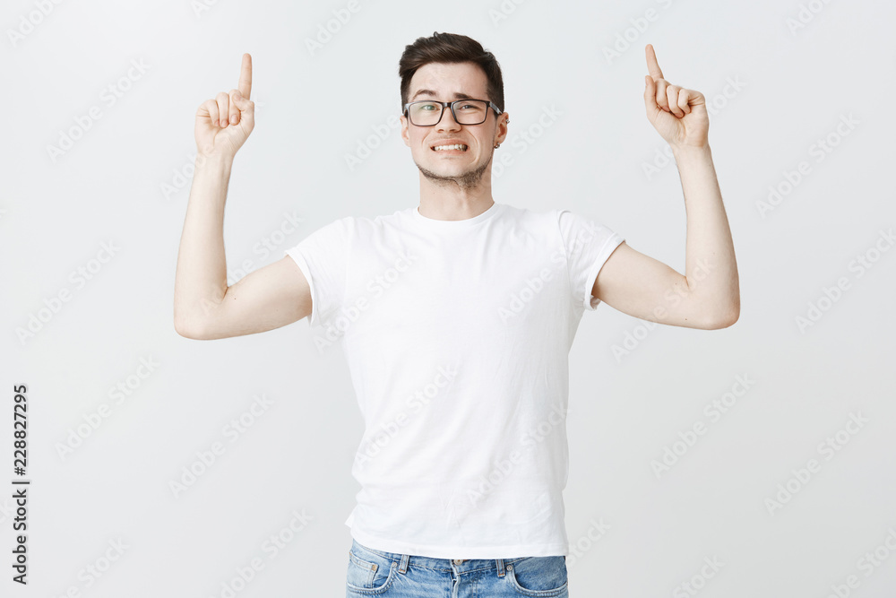 Ouch that hurts. Intense worried and awkward young male model in ...