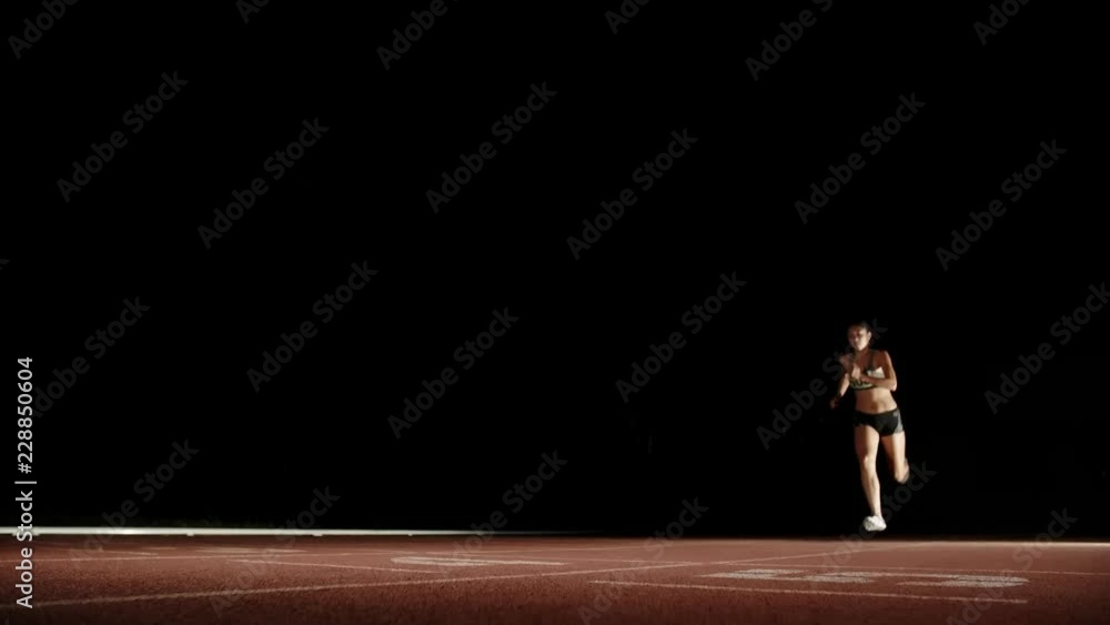 Athlete running on short track. Female asian runner heading forward on ...