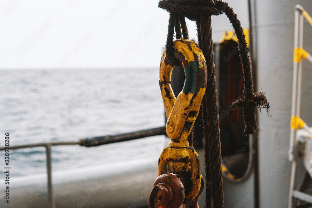 Offshore crane hook is secured for sea passage. Cargo operations at sea ...