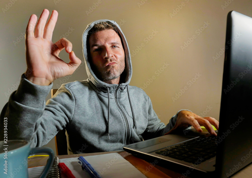 young attractive and dangerous looking hacker computer geek working on ...