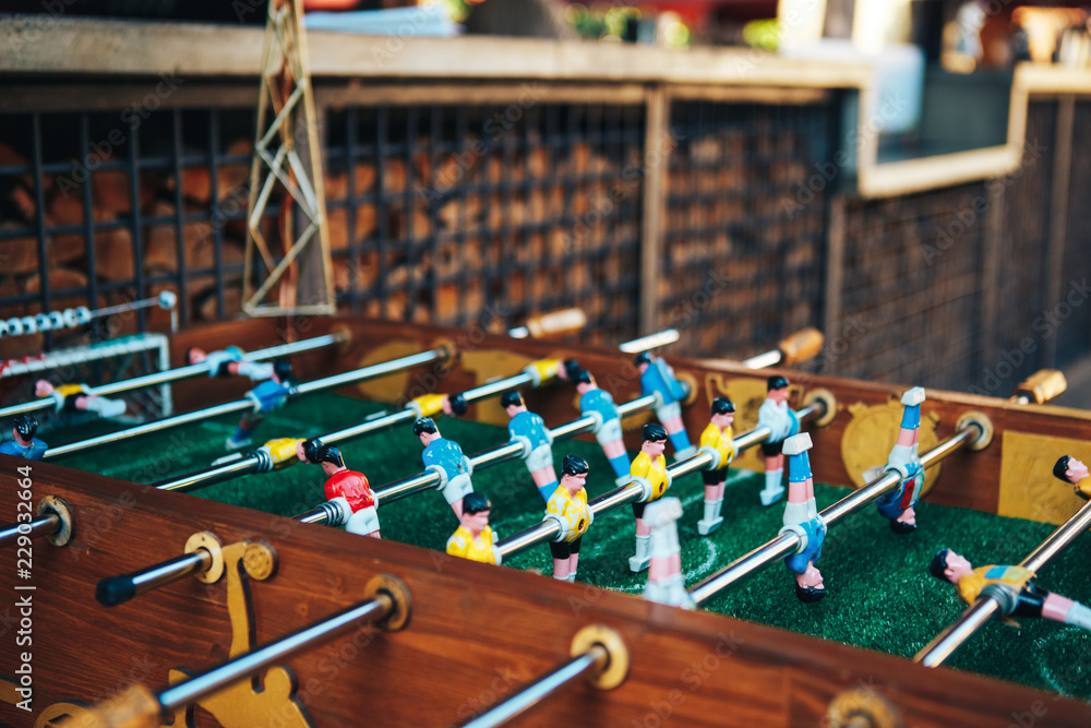 Table soccer. Blue and yellow team players in table football or a ...