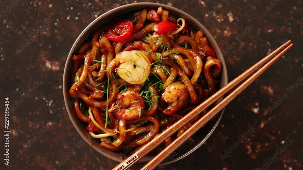 Traditional asian udon stir-fry noodles with shrimp in bowl and ...