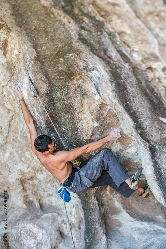 The last movements to reach the summit by a male climber. Rock climbing ...