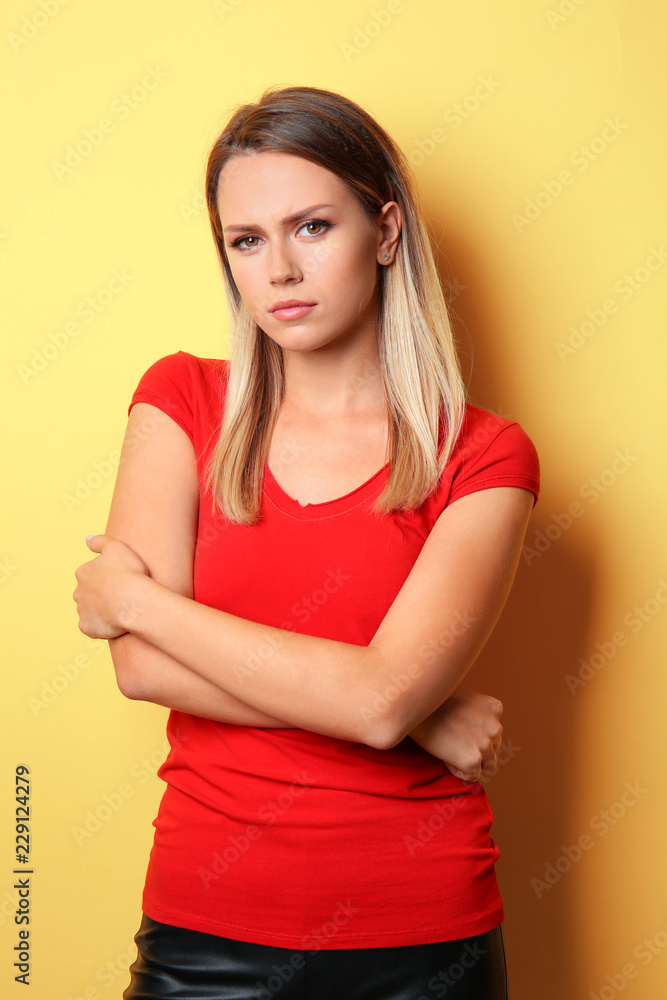 Beautiful frowning young woman on color background Stock Photo | Adobe ...