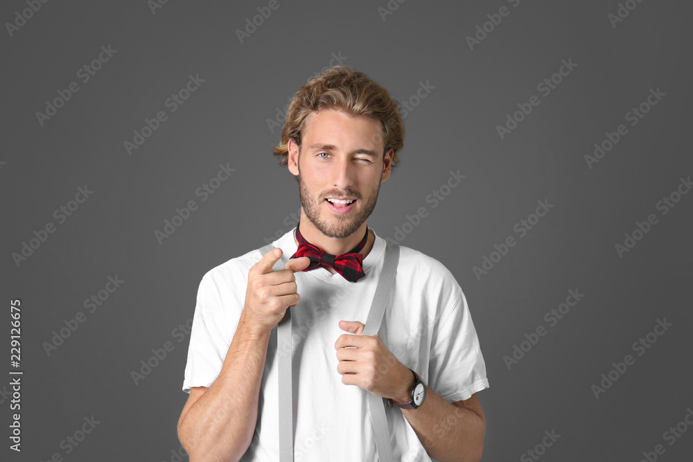 Portrait of handsome man pointing at viewer on grey background Stock ...