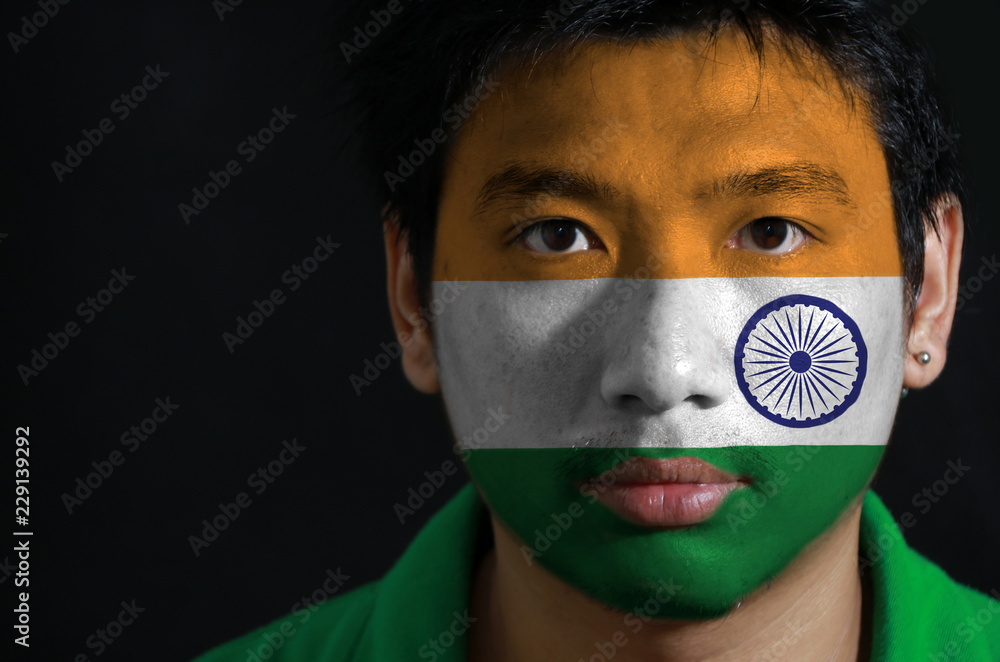 Portrait of a man with the flag of the India painted on his face on ...
