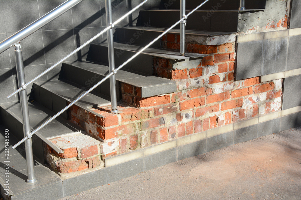 Broken house steps foundation with water leaks outdoor. Damaged stair ...