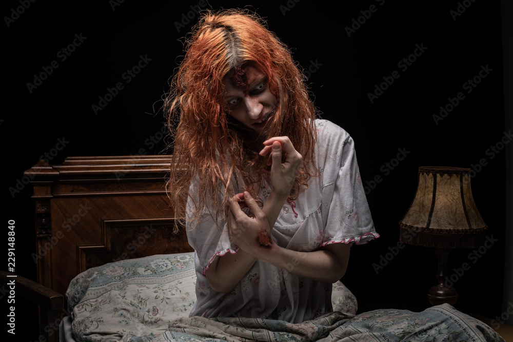 Scary woman possessed by devil in the bed. Exorcism of priest. Stock ...