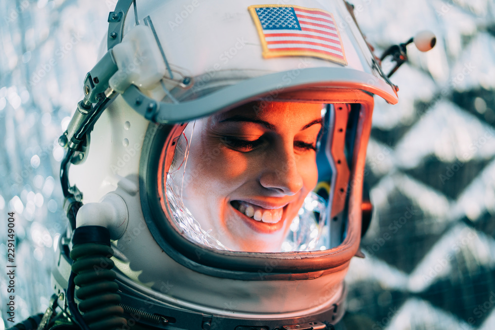 Beautiful woman poses dressed as an astronaut. Stock Photo | Adobe Stock