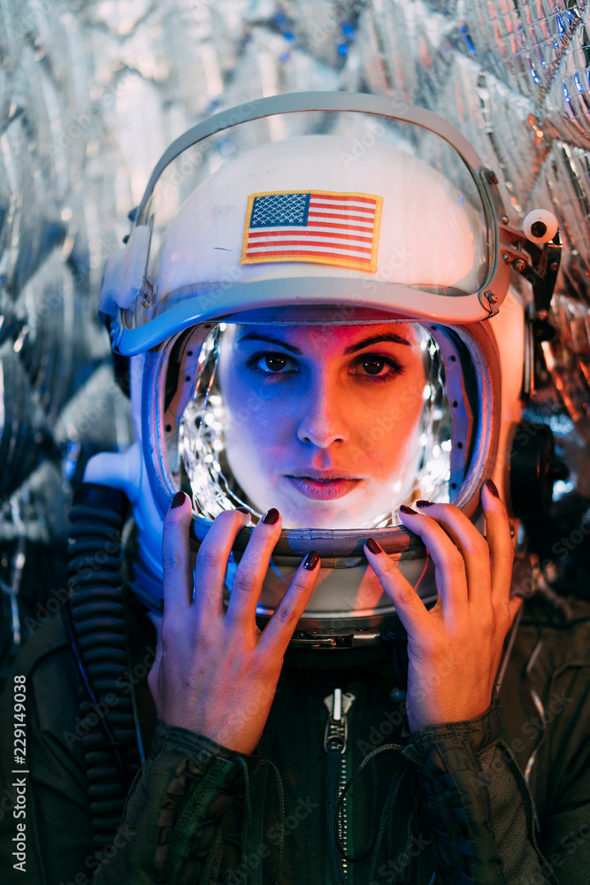 Beautiful woman poses looking at camera dressed as an astronaut. Stock ...