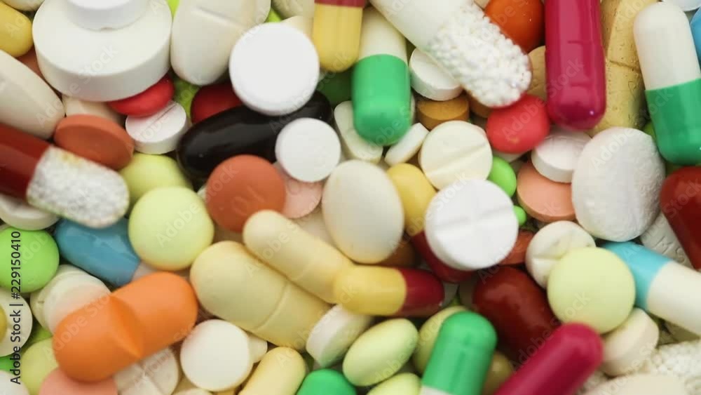 Closeup shot of colorful selection of pills spinning Stock Video ...