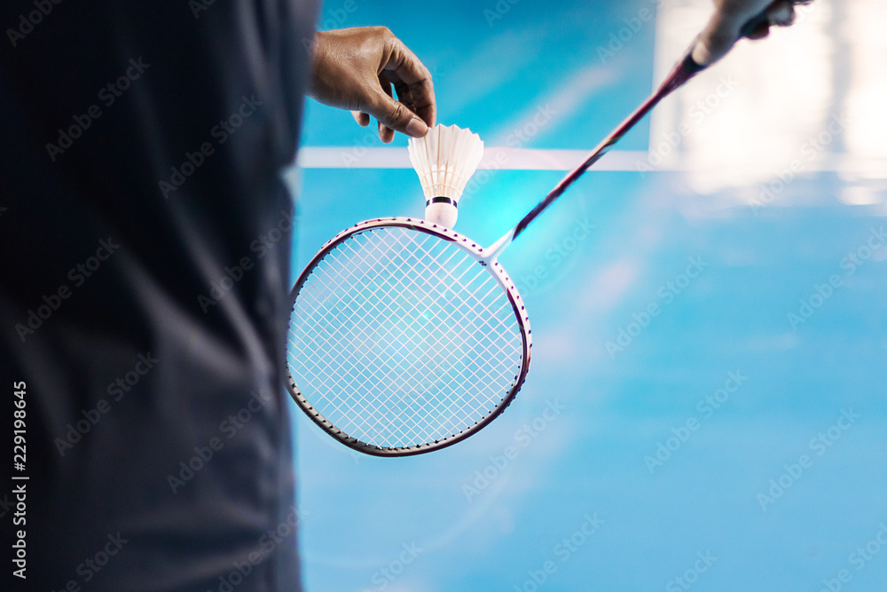 People Playing Badminton, Badminton is served on court blue background ...