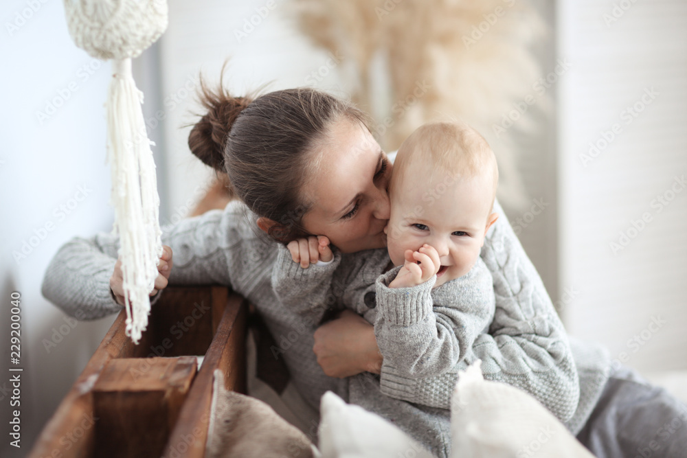 mom hugs charming baby,motherhood in real interior Stock Photo | Adobe ...