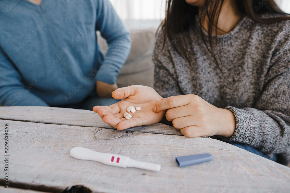 Man comforting his frustrated wife after pregnancy test result ...