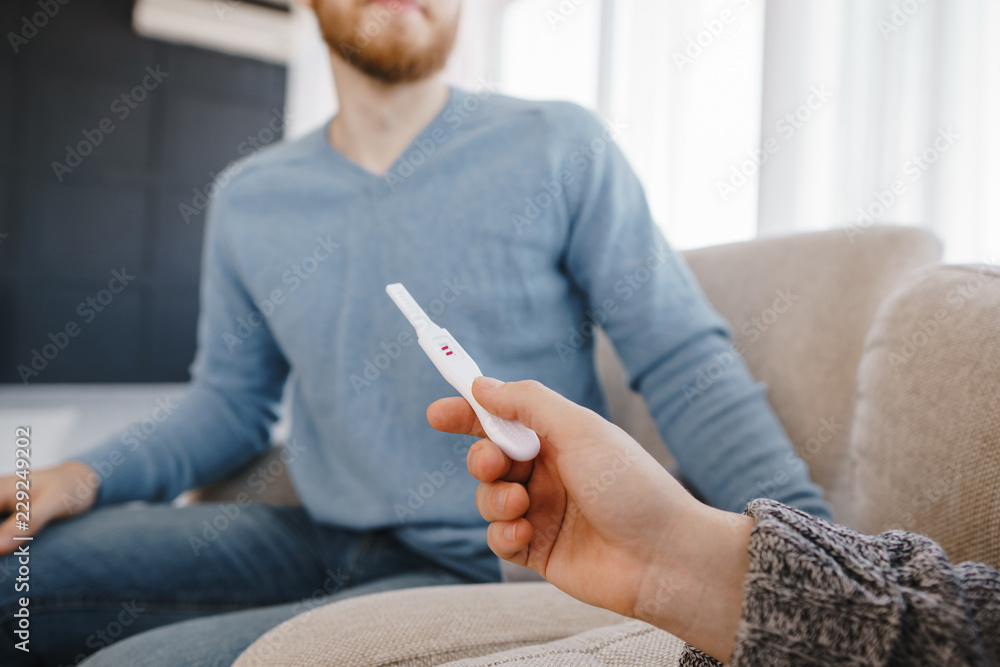 Woman showing positive pregnancy test results to her partner. Pregnancy ...
