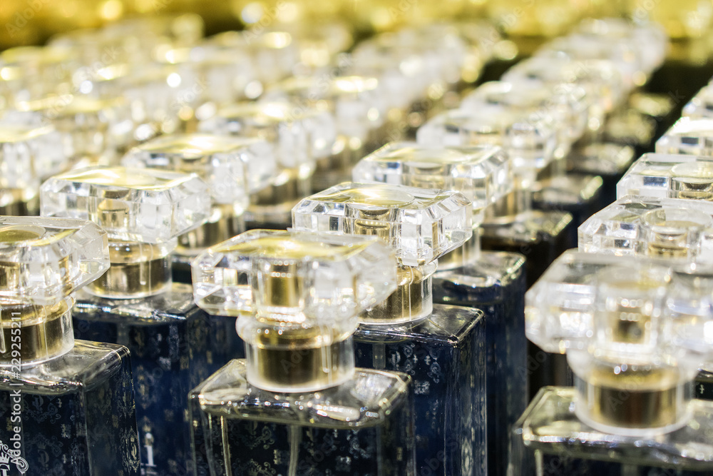 Many bottle of various men woman perfume in retail shop window display ...