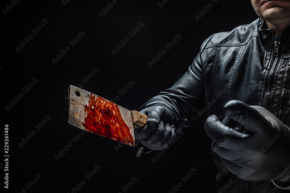 Serial killer's hand with bloody meat cutter and black gloves Stock ...