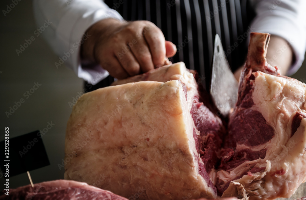 Butcher cutting rib eye steak food photography recipe idea Stock Photo ...