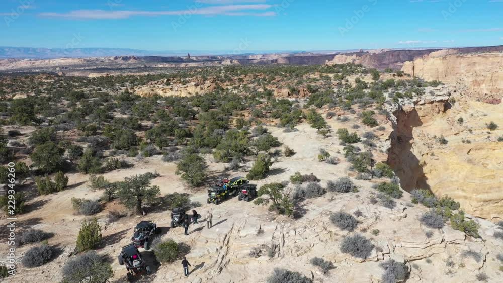 Aerial friends riding off road 4x4 desert mountain cliff . San Rafael ...