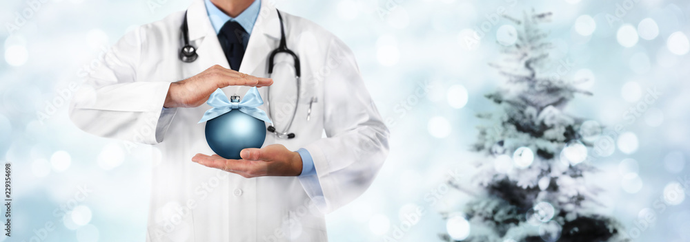 Merry Christmas from doctor,, best wishes concept, hands with xmas ball ...