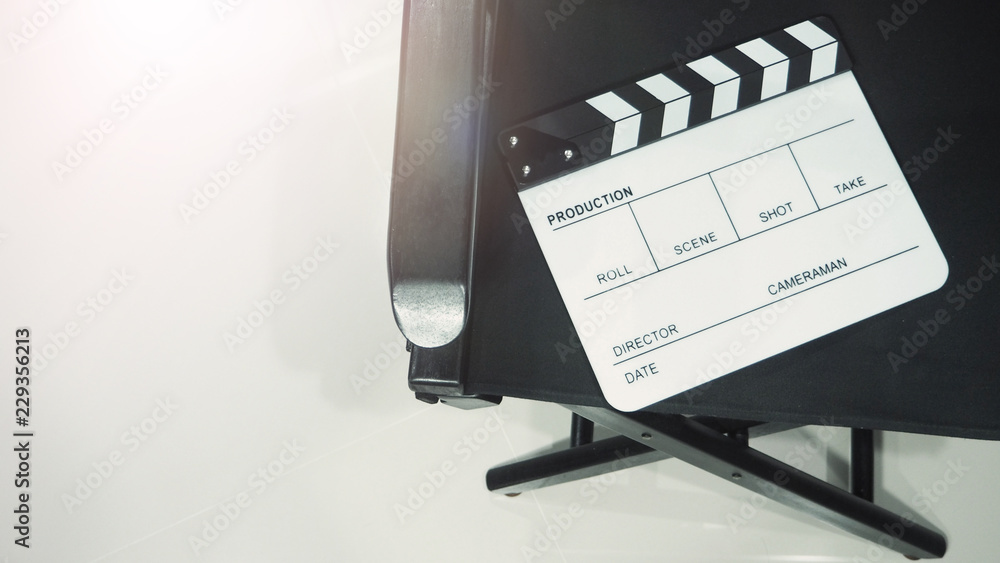 Clapper board or clap board or movie slate with black director chair use in video production ...