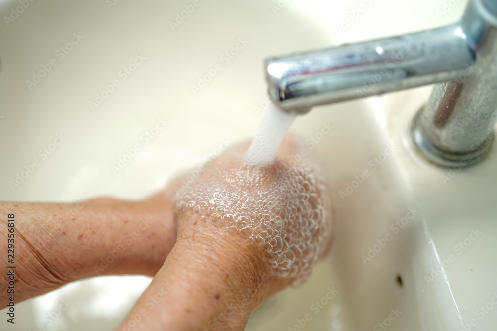 Asian senior elderly old lady woman patient washing hands in the ...