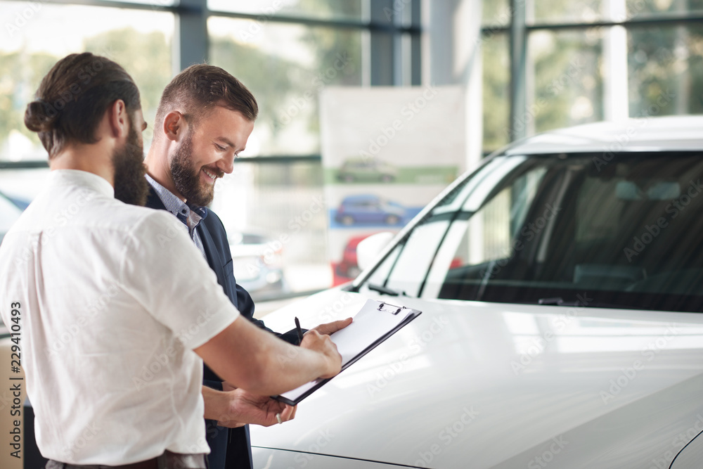 Customer of car signing documents of purchase on folder. Stock Photo ...