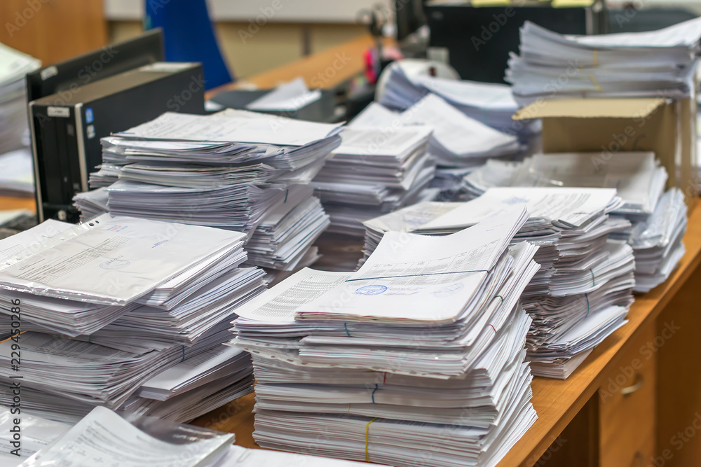 bundles bales of paper documents. stacks packs pile on the desk in the ...