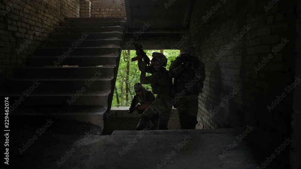 Elite squad of special force marines fully equppied and armed storming ...